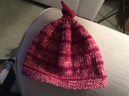 Tegan Baby Hat with Top Knot Knitting pattern by Julie Taylor | LoveCrafts